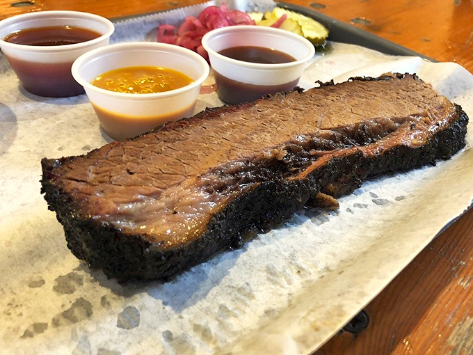 Behold the brisket&mdash;dark bark on the outside, tender perfection inside. Those three sauce options are like choosing between your favorite children.