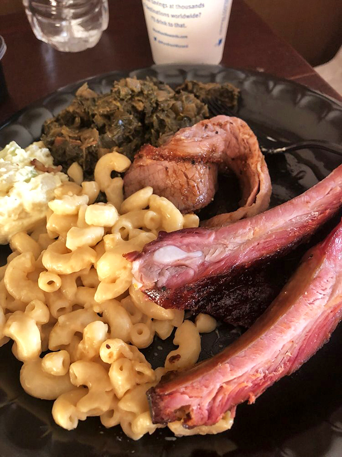 The holy trinity of barbecue: ribs, mac and cheese, and greens. A plate that would make even vegetarians consider a temporary career change.