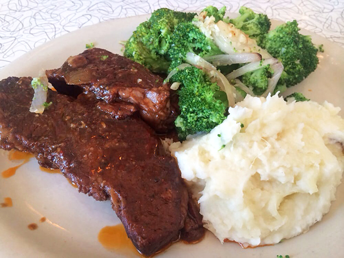Tender brisket glistening with sauce alongside cloud-like mashed potatoes and vibrant broccoli&mdash;a plate that whispers, "Diet? What diet? We're on vacation."