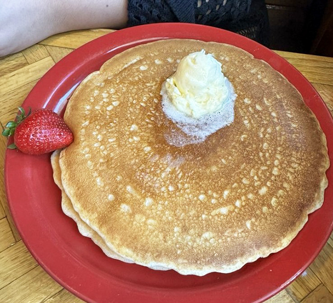 Pancake perfection defined! Golden-brown, plate-sized, and topped with a melting pat of butter that creates little rivers of deliciousness with each cut.