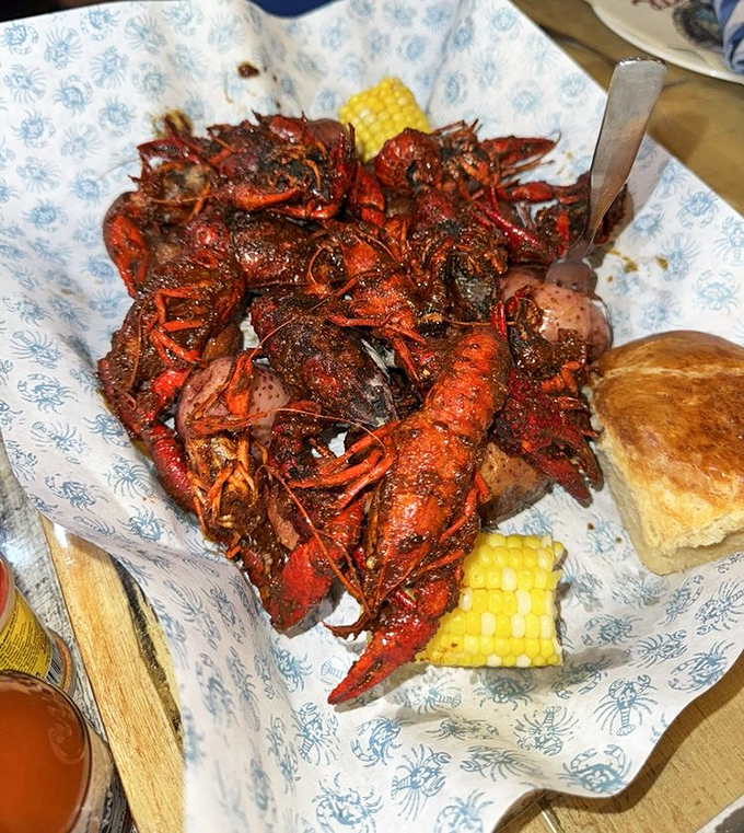 Crawfish piled high like tiny crimson treasures, served with corn and bread for sopping up that spicy, soul-satisfying sauce.