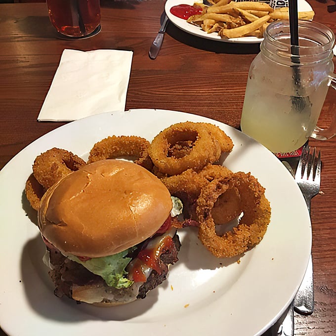 A proper burger requires structural engineering, a soft bun, and the understanding that napkins aren't just a suggestion but a necessity.