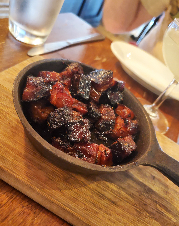 These burnt ends look like they've been kissed by fire and blessed by smoke&mdash;glistening, caramelized meat candy in a cast iron skillet.