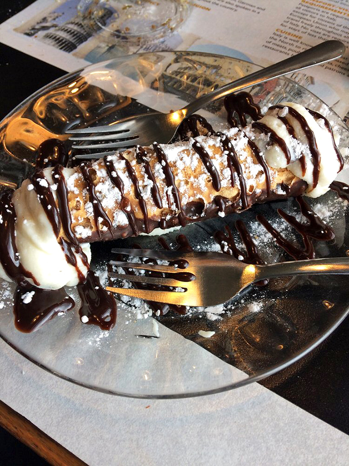 This cannoli isn't just dessert; it's a powdered-sugar masterpiece that would make even the Godfather pause mid-sentence.