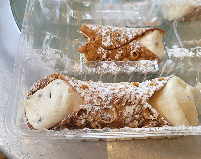 These cannolis aren't just dessert; they're tiny tubes of happiness with crisp shells giving way to sweetened ricotta that would make any nonna proud.