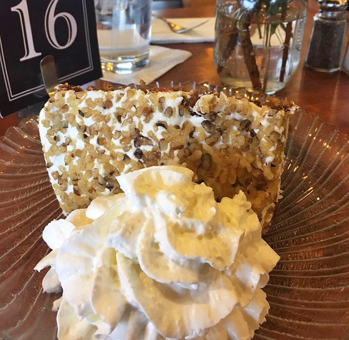 Carrot cake wearing a crown of whipped cream and walnut confetti. The kind of slice that makes you wonder why anyone bothers with birthday cake.