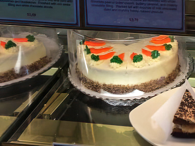 Carrot cake wearing cream cheese frosting like a Sunday hat, ready for its close-up.