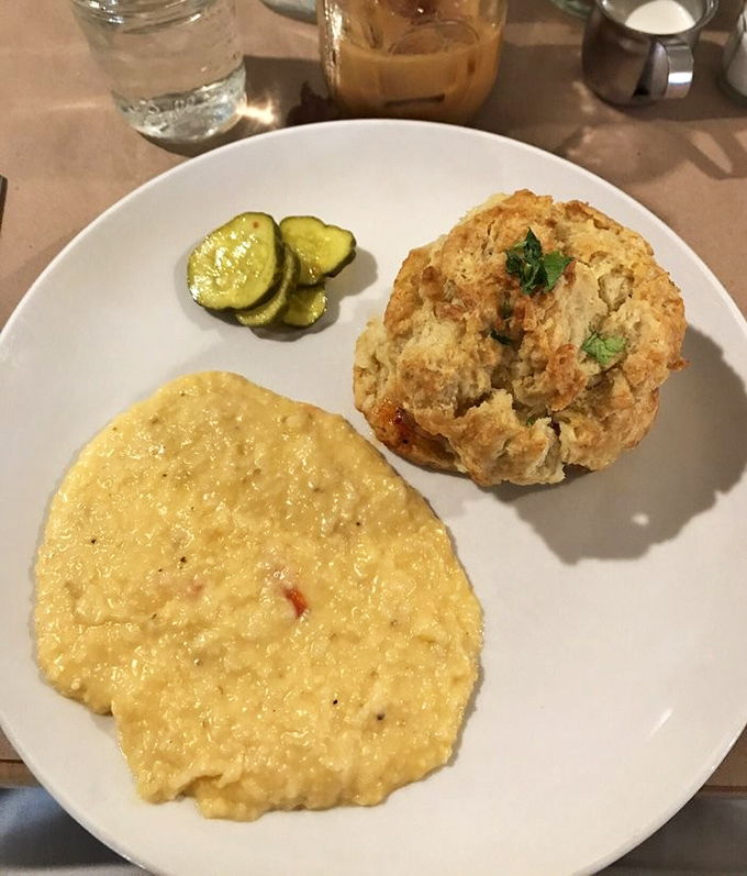 Southern comfort on a plate: creamy cheese grits alongside a towering biscuit. Comfort food that hugs your soul from the inside.