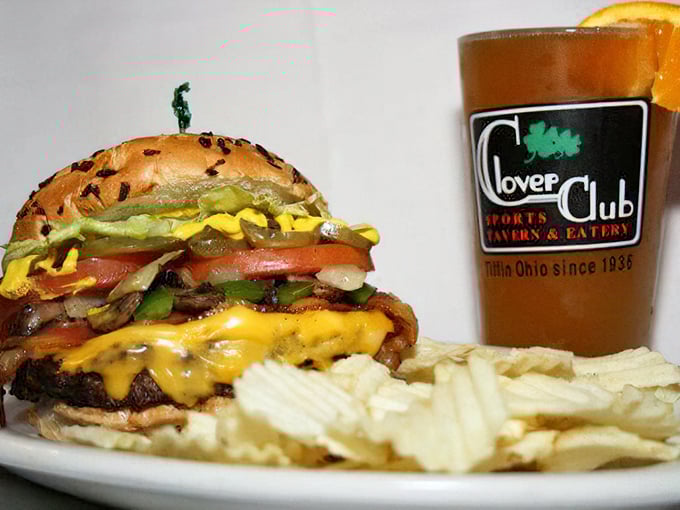 This isn't just a burger; it's architecture. The melted cheese cascading down the sides like delicious lava while the perfectly toasted bun stands ready for duty.