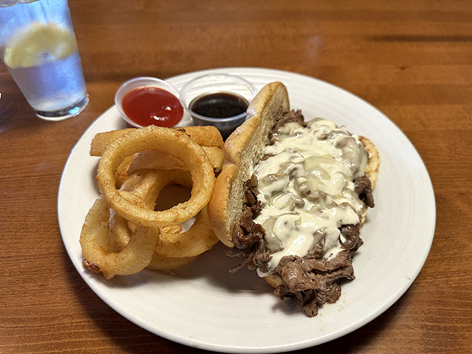 A French dip that would make a Parisian jealous. Those onion rings aren't just sides &ndash; they're crispy golden halos of happiness.