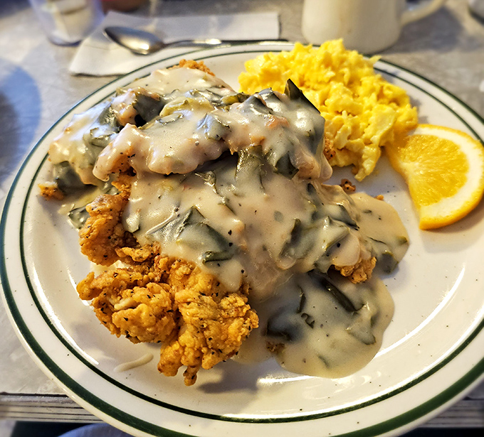 Chicken and gravy cascading over golden scrambled eggs&mdash;a breakfast that doesn't just start your day, it makes your whole week.