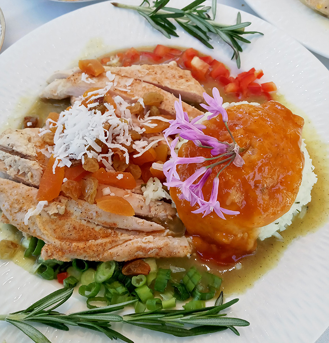 Chicken curry that doesn't hold back on flavor or presentation. Those edible flowers aren't just pretty faces&mdash;they're part of the experience.