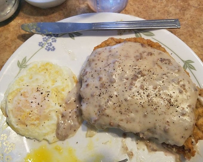 Country gravy blankets this chicken fried steak like a warm winter comforter, turning a humble cut into something worth crossing town for.