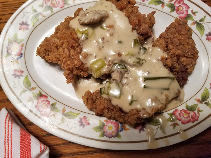 Country fried steak smothered in gravy with green onions&mdash;a dish so comforting it's like getting a hug from your favorite aunt who doesn't judge your life choices. 