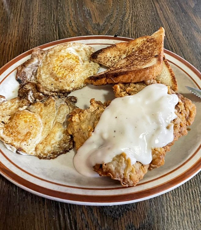The chicken fried steak with gravy arrives like the headliner it is, flanked by golden eggs and toast &ndash; breakfast doesn't get more Texan than this.