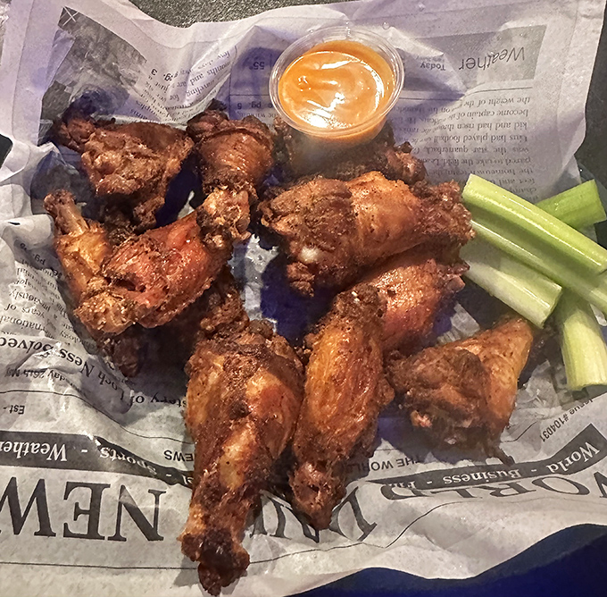 Wings so crispy they practically shatter at first bite, served unpretentiously on paper with celery sticks and cooling sauce. Sometimes the best things come in simple packages.