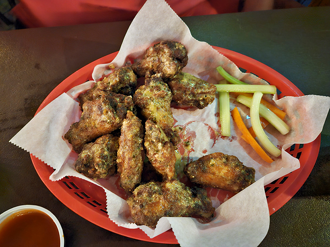 Golden chicken wings arrive like edible treasures, crispy outside and tender within, demanding immediate attention and napkins.