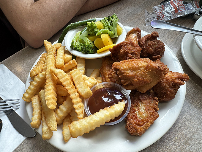 The famous chicken wings that inspire detours! Golden-crisp outside, juicy inside, with crinkle-cut fries that deserve their own fan club.