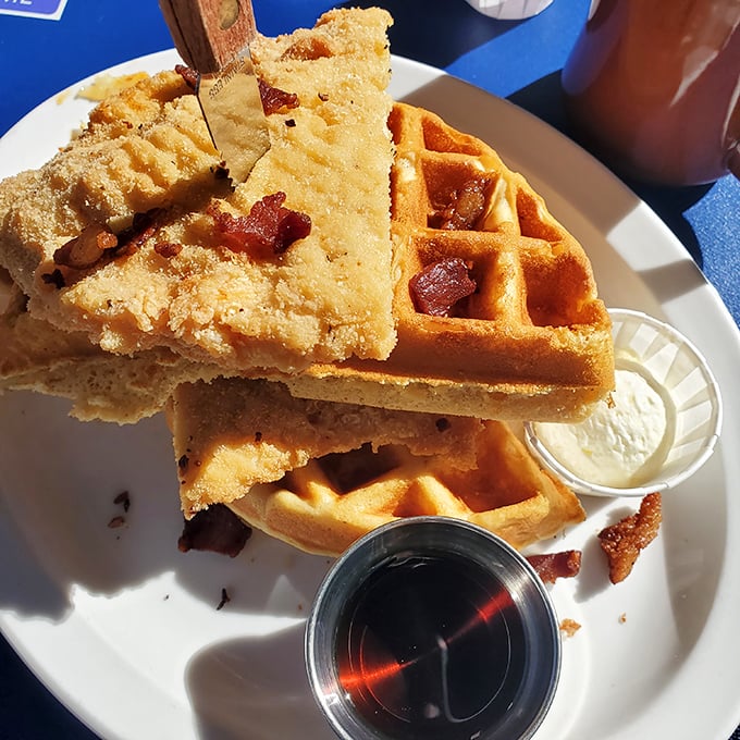 Waffles and chicken living their best lives together on one glorious plate. The bacon bits are like confetti celebrating this perfect union of sweet and savory.