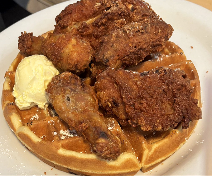 Chicken and waffles that breaks the laws of physics&mdash;impossibly crispy chicken atop a fluffy waffle. The scoop of butter melts with cinematic timing.