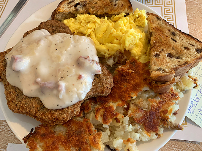 Country-fried steak with gravy isn't just breakfast—it's edible armor against whatever the day might throw at you. Those home fries aren't bad reinforcements either.