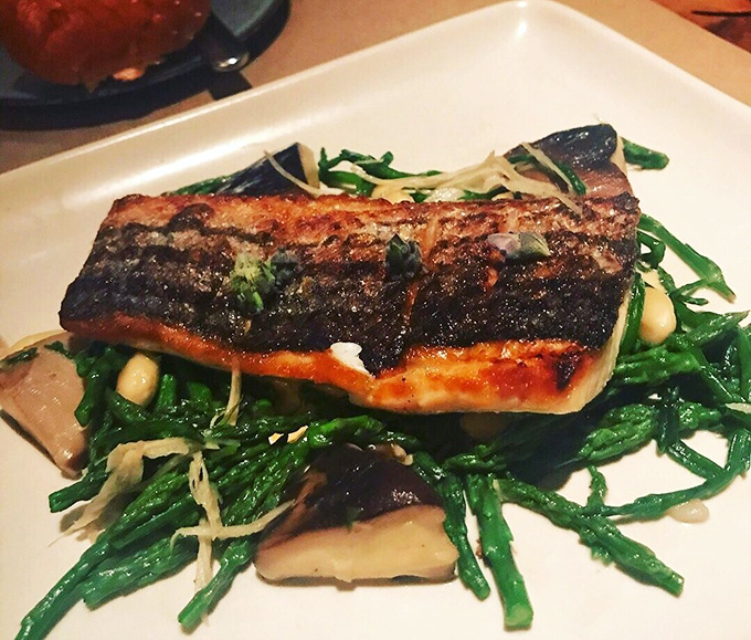 Sea bass so perfectly charred it deserves its own Instagram account. Ocean-to-plate poetry served on a bed of greens that somehow became the supporting actor worthy of their own Oscar.