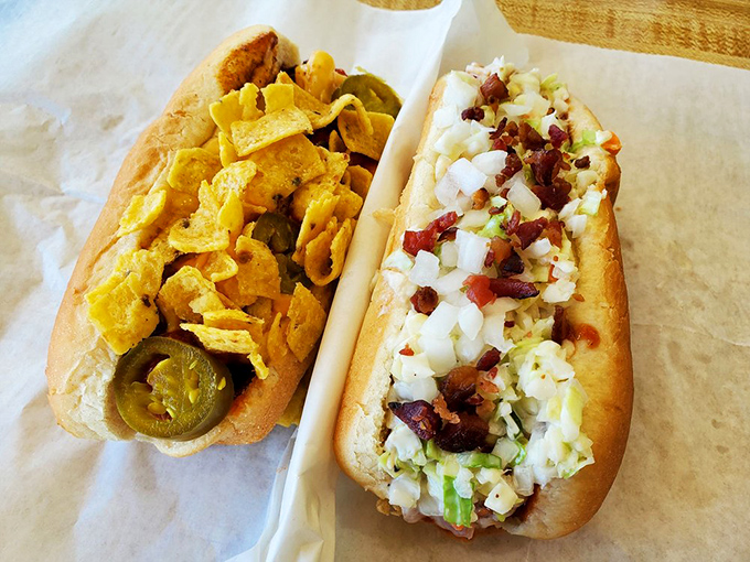 Two dogs, two personalities: one flaunting jalape&ntilde;os and corn chips like jewelry, the other showcasing the timeless elegance of bacon and onions.