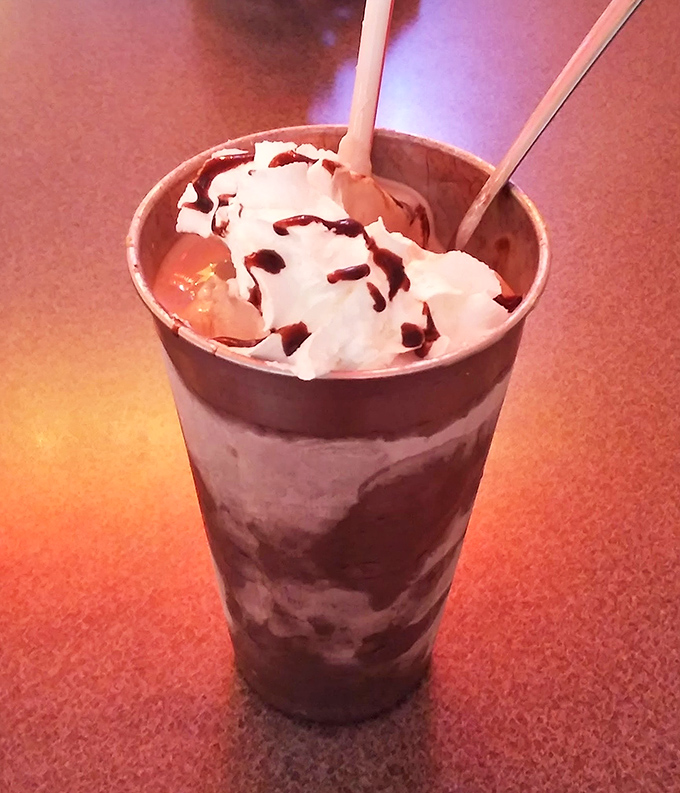 The chocolate milkshake arrives like a dessert skyscraper&mdash;thick enough to require serious straw commitment, topped with a cloud of whipped cream that defies gravity.