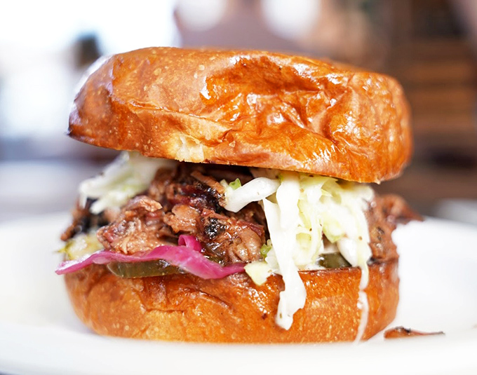 The sandwich that launches a thousand naps. Chopped brisket nestled in a toasted bun with crisp slaw and pickled onions for that perfect acid counterpoint.