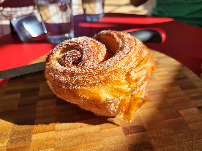 The cinnamon roll that launched a thousand return visits. Golden, swirled, and dusted with just enough sugar to make you weak-kneed.