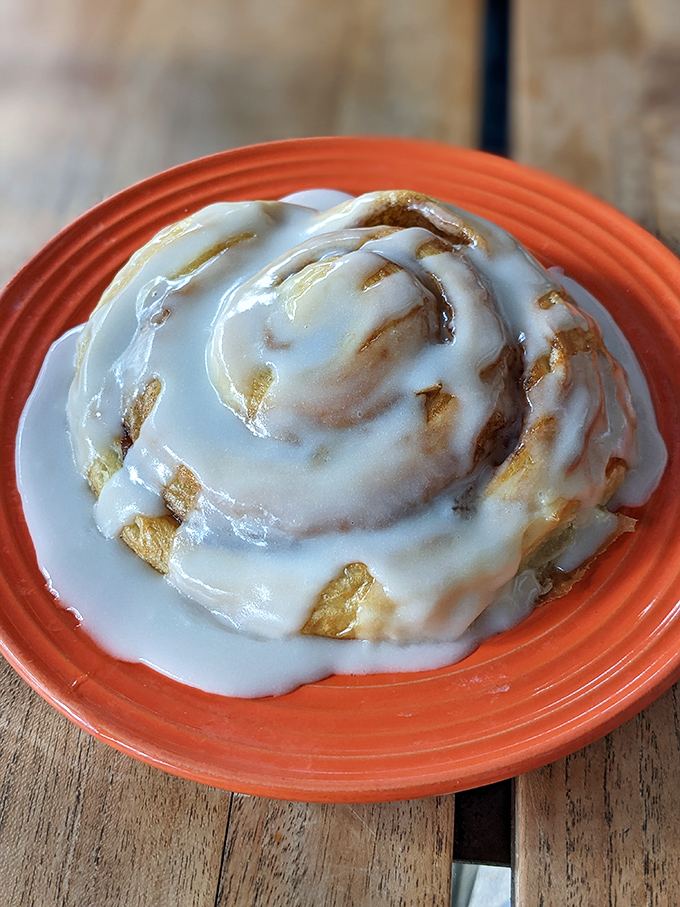 The cinnamon roll that launched a thousand return visits. That glaze doesn't drip, it embraces every warm, cinnamon-scented curve.