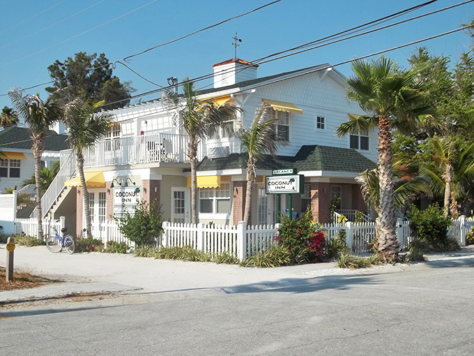 The Coconut Inn epitomizes Old Florida charm with its white picket fence and yellow awnings. Bed-and-breakfast perfection without a corporate logo in sight.