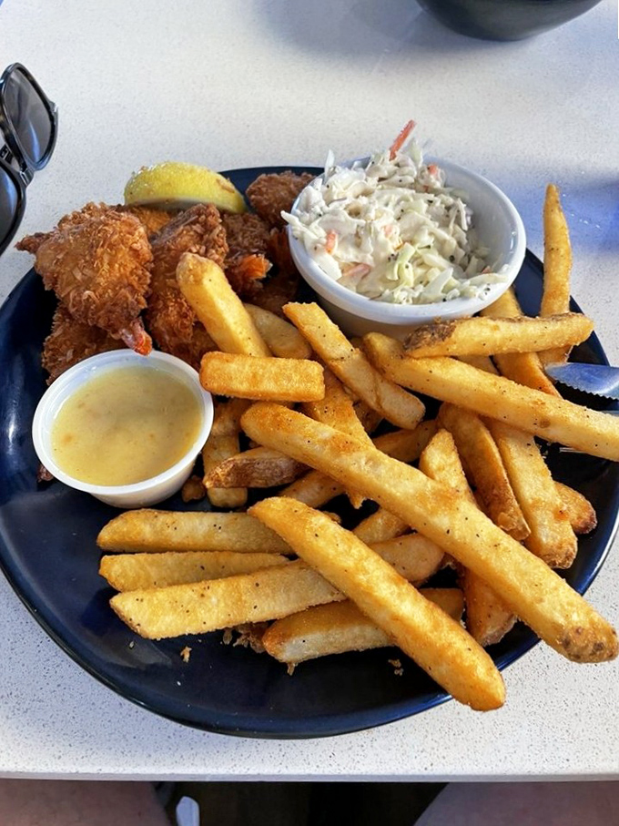 Golden-fried coconut shrimp that snap like tiny firecrackers. Paired with crispy fries and homemade coleslaw, it's vacation on a plate.