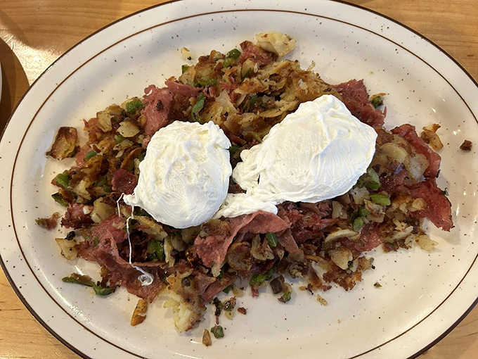 Corned beef hash topped with perfectly poached eggs&mdash;the breakfast equivalent of hitting the lottery. Those yolks are about to create a sauce that dreams are made of.