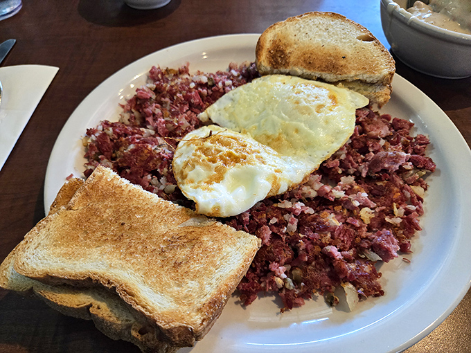 Corned beef hash that puts the canned stuff to shame, topped with sunny-side-up eggs and toast for sopping up every last morsel.