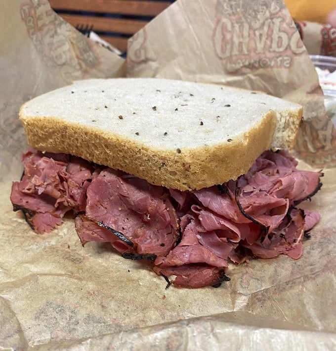 Corned beef so tender it practically surrenders to gravity, stacked between slices of rye bread. This isn't a sandwich &ndash; it's an engineering marvel.