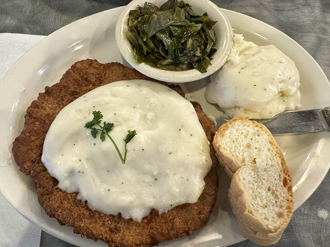 Country fried steak smothered in gravy with a side of collards&mdash;the kind of plate that makes you want to hug the cook and steal their recipe.