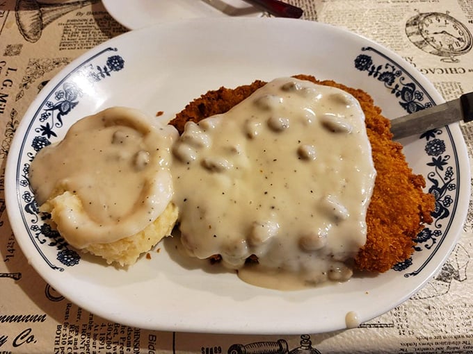 Country fried steak swimming in creamy gravy&mdash;where Southern comfort meets Midwestern portion sizes. Your cardiologist won't approve, but your soul will.