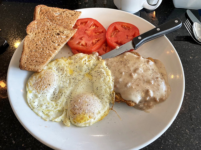 Country fried steak with sausage gravy: where breakfast meets therapy. Those eggs are just hanging out, wondering how they'll compete with that gravy.