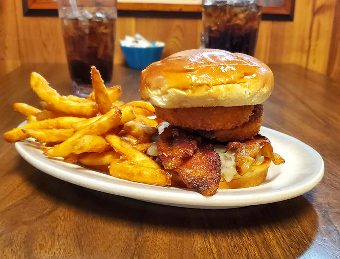 The Cowboy Burger doesn't ride into town quietly—it arrives with bacon blazing and cheese melting, flanked by a posse of golden fries.