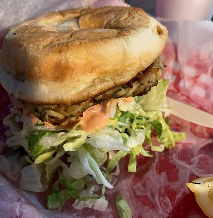 Not your average sandwich &ndash; this crab cake creation towers with fresh lettuce and secret sauce on a perfectly toasted bun.