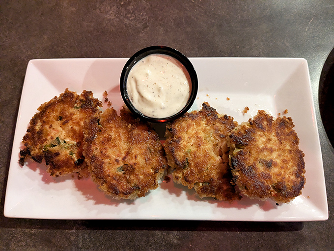 These golden-brown crab cakes aren't just fried, they're a crispy love letter to the sea &ndash; perfectly paired with that creamy dipping sauce.