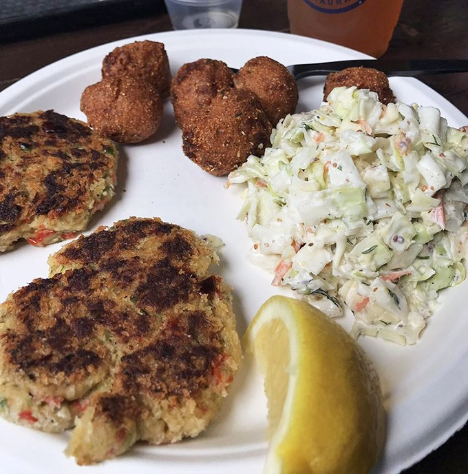 Crab cakes with the perfect sear, hush puppies with attitude, and coleslaw that didn't come from a plastic tub. This plate means business.