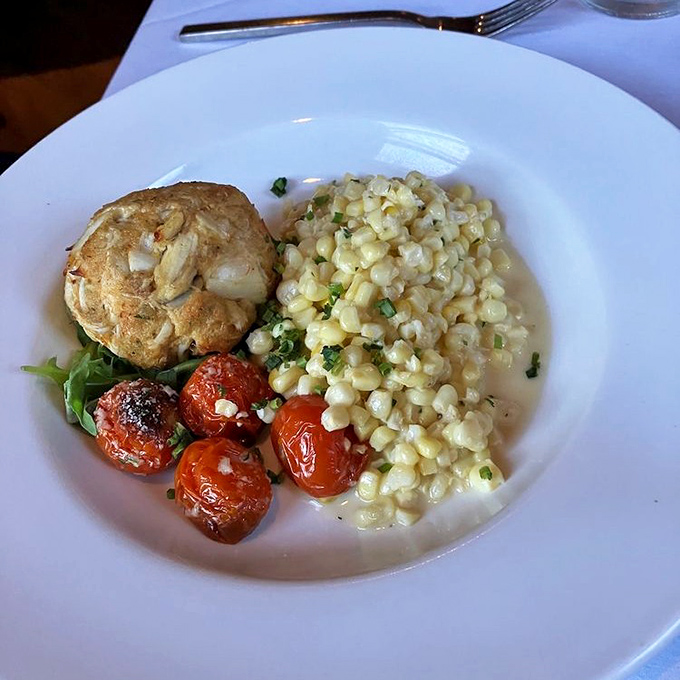 Maryland's signature dish done right. This golden-brown crab cake with sweet corn is what seafood dreams are made of.