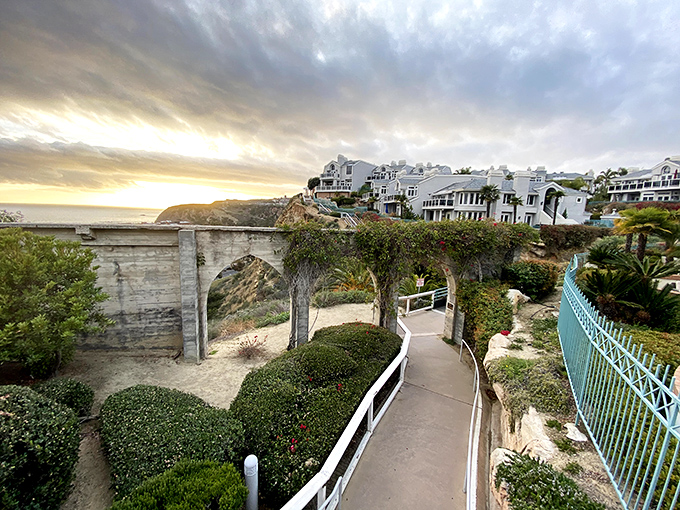 The historic Dana Point Arches frame a pathway to paradise, where sunset strolls become memory snapshots worth more than any souvenir.