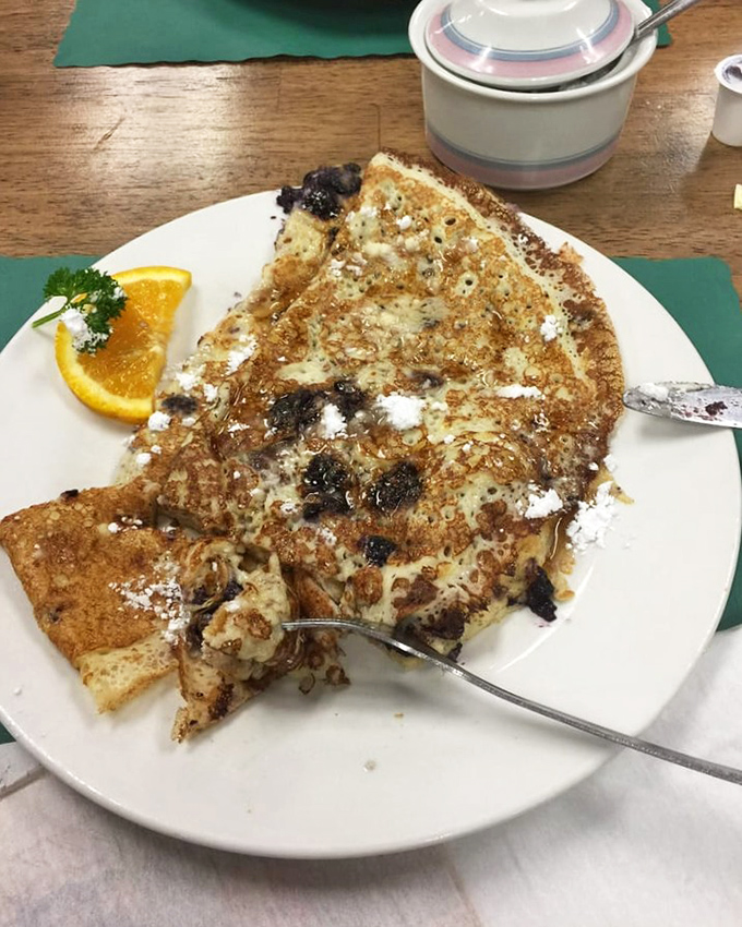 This Danish pancake with blueberries isn't just breakfast&mdash;it's edible art with powdered sugar snow and a side of morning sunshine.