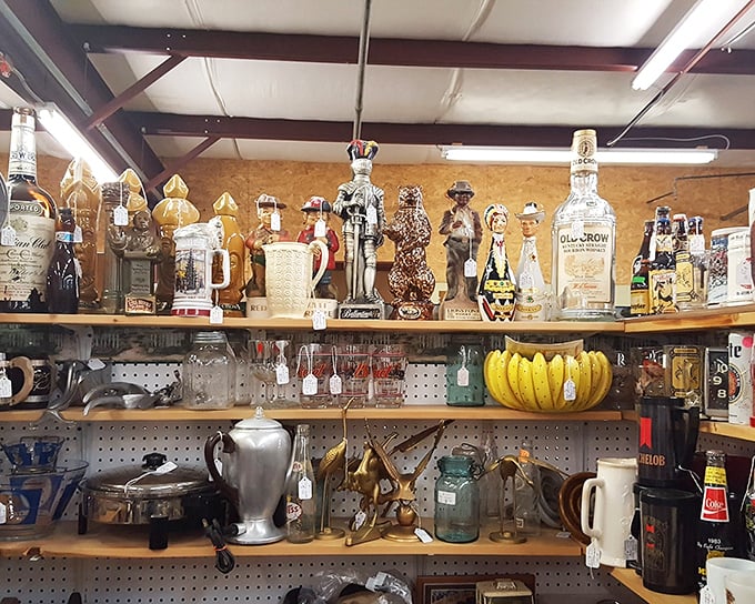 The curious lineup of decorative decanters and figurines stands at attention. Jim Beam bottles never looked so dignified in their retirement years.