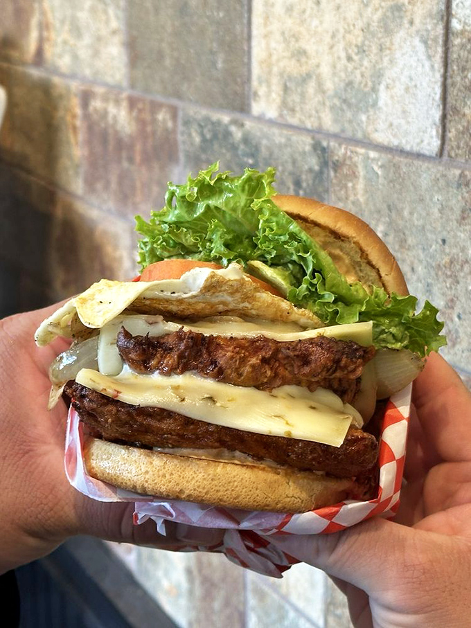 Layer upon layer of burger engineering at its finest. The Swiss cheese cascade alone would make the most disciplined dieter weak at the knees.