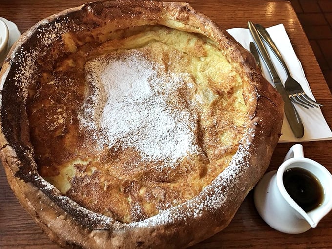 The Dutch Baby arrives like a golden crater from breakfast outer space, dusted with powdered sugar and ready for its lemon squeeze.