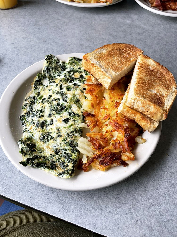 This spinach omelet isn't just healthy&mdash;it's a masterpiece of green and gold, paired with hash browns so perfectly crispy they deserve their own fan club.